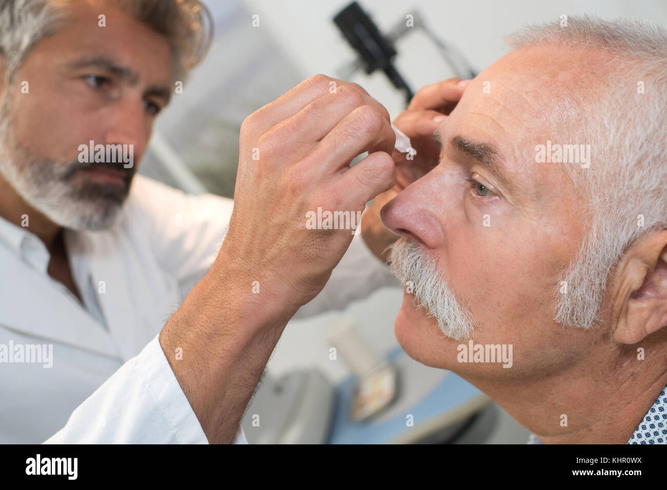 doctor helps the patient and gives the eye drops Stock Photo - Alamy