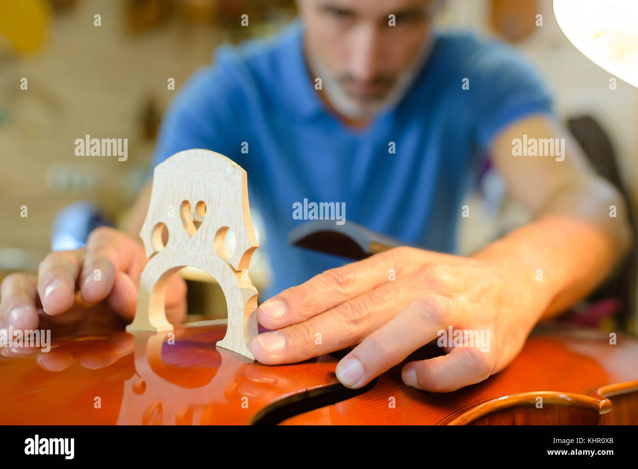 installing string instrument bridge Stock Photo - Alamy