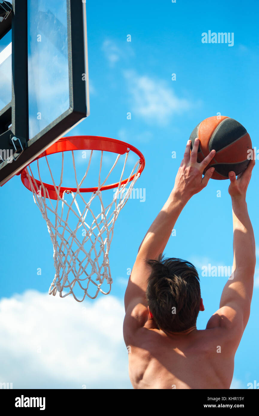 Basketball player throws a ball Stock Photo - Alamy