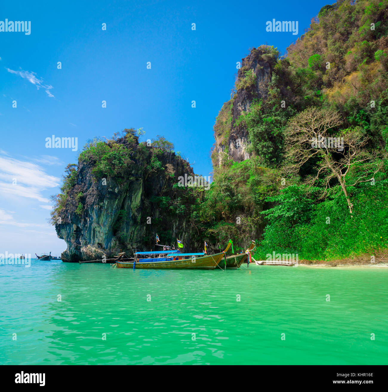 Traditional longtail boats near tropical island Stock Photo - Alamy