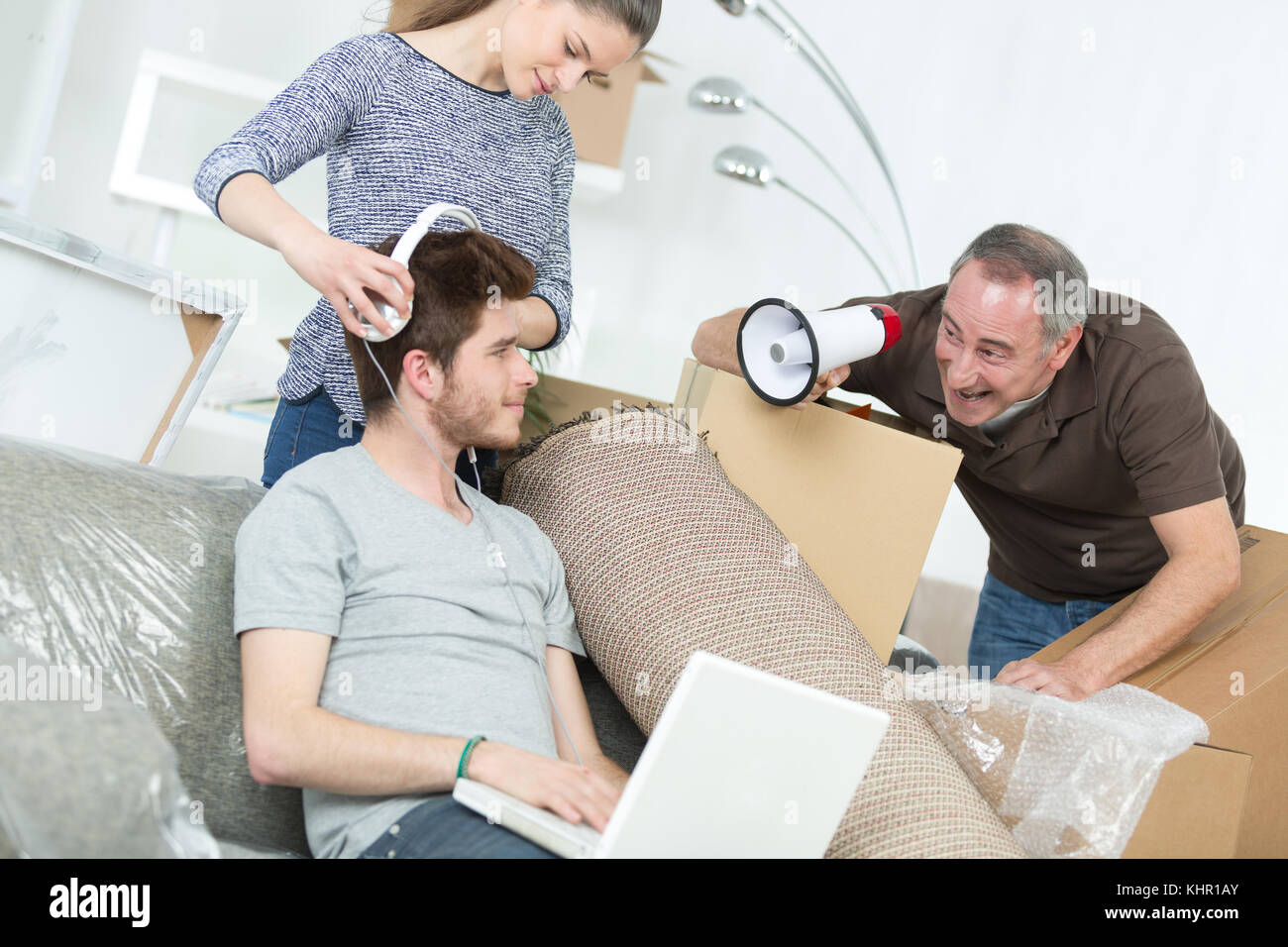 man surfing the internet while angry father uses a megaphone Stock ...