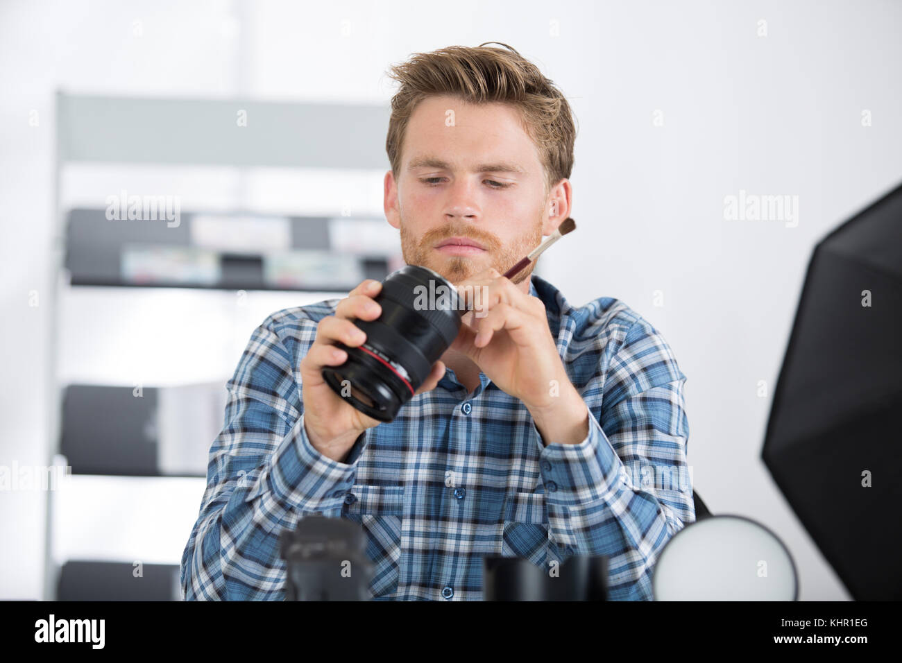 man inspecting the camera lens Stock Photo - Alamy