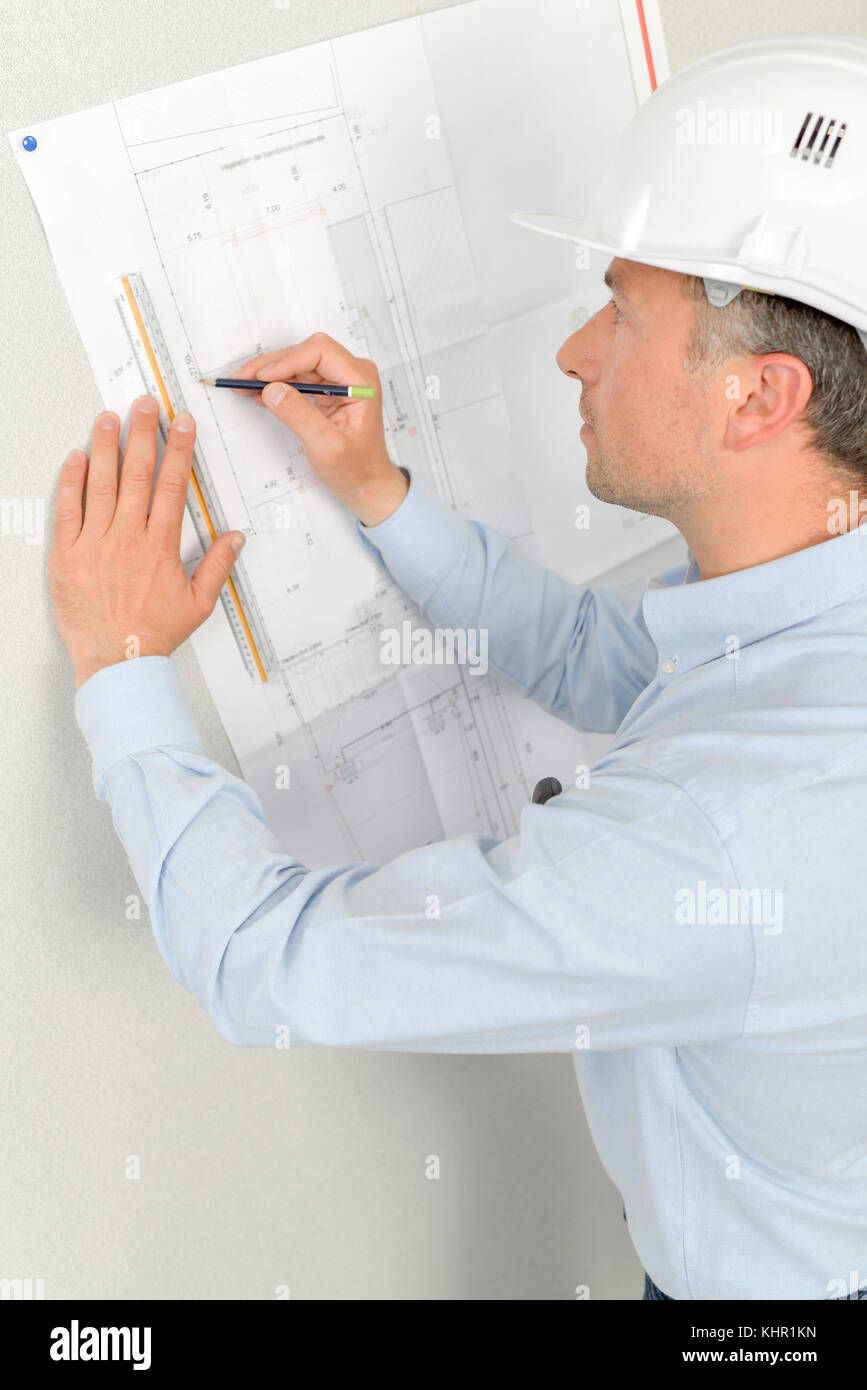 man drawing on blueprints Stock Photo - Alamy