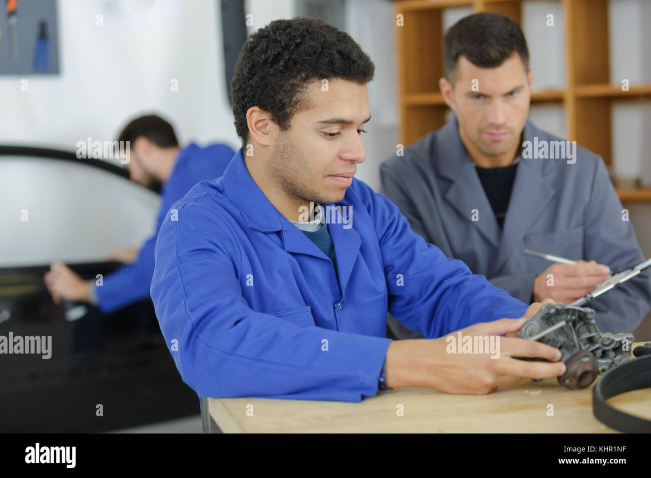 car mechanic working at work table in auto repair service Stock Photo ...