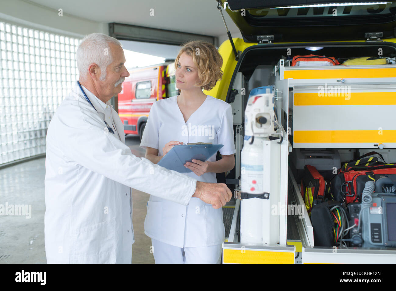 emergency doctor and nurse standing in front of ambulance car Stock ...