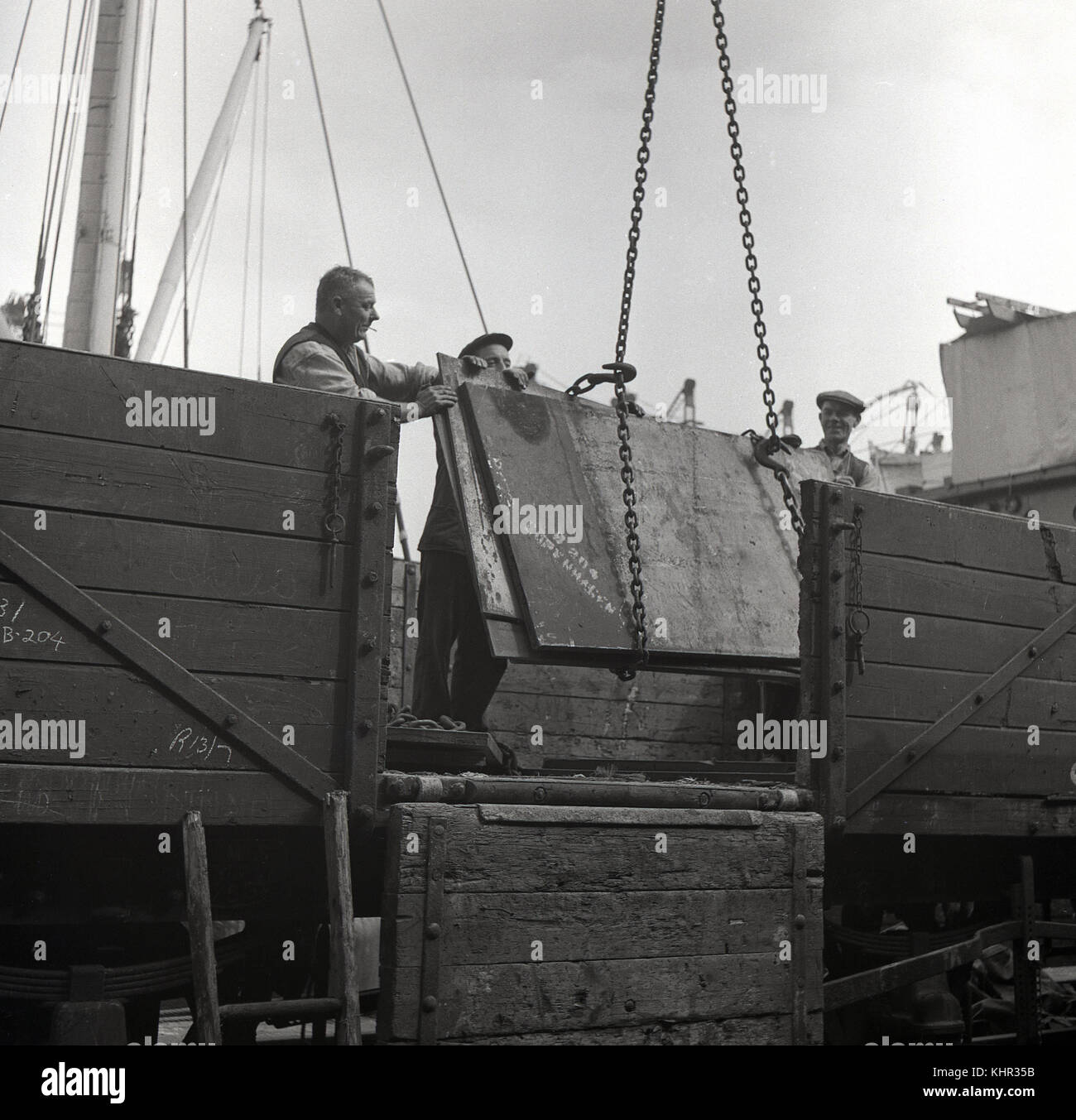 1950s, historical, three male workers in a railway goods wagon at ...
