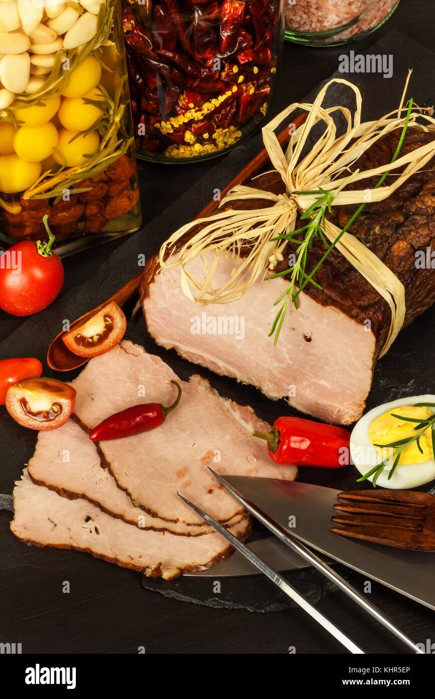 Traditional smoked meat on kitchen table. Culinary meat eating. Sales ...