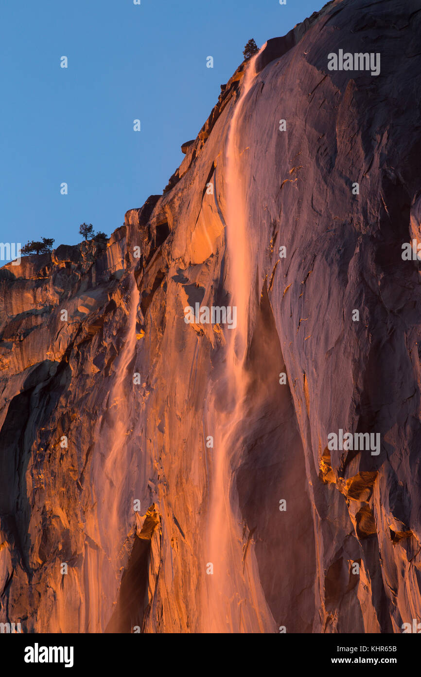 Horsetail Fall, low sun angle lights the rock wall during sunset ...