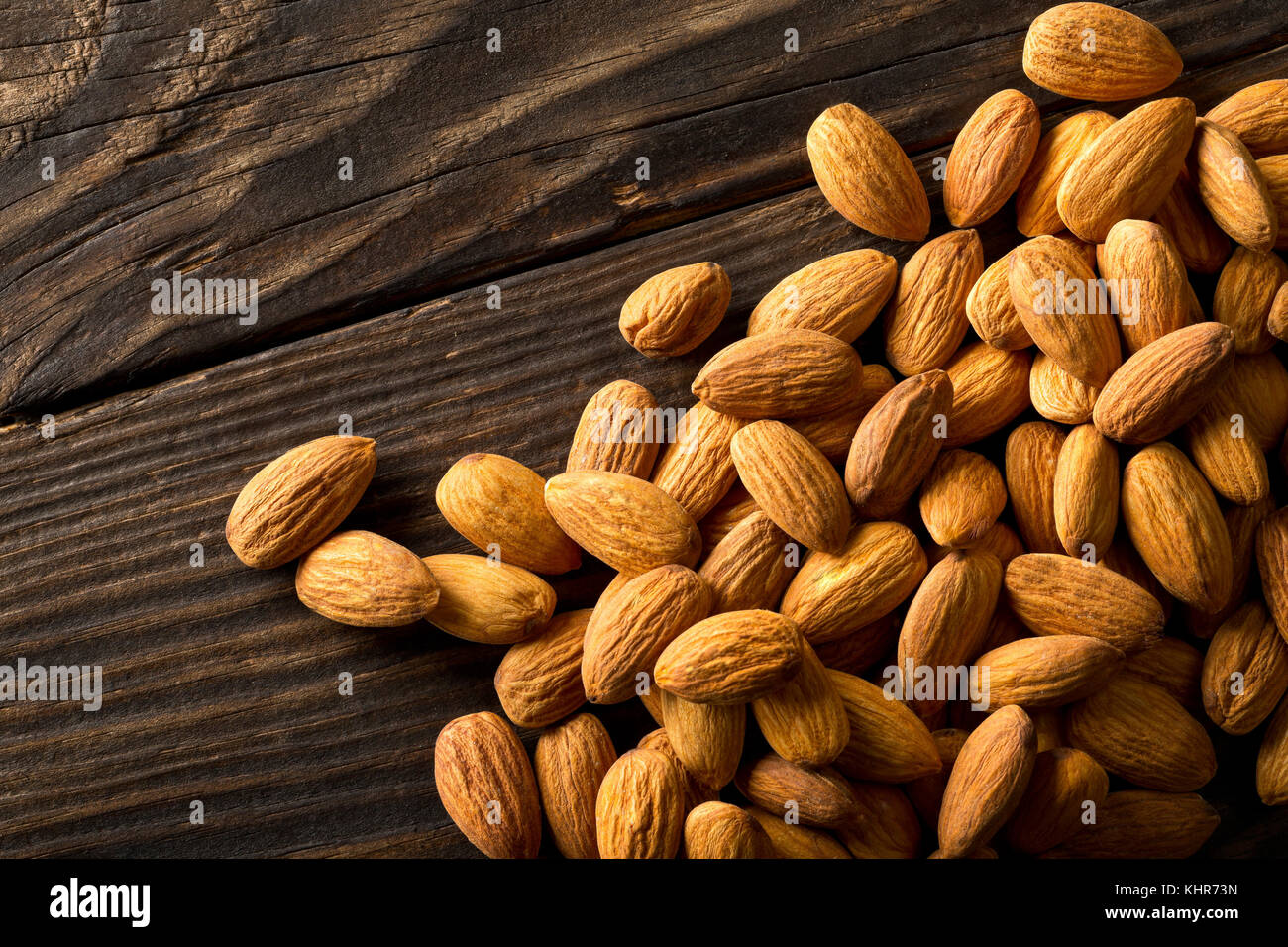 Heap of shelled almond kernels on dark wooden table background Stock ...