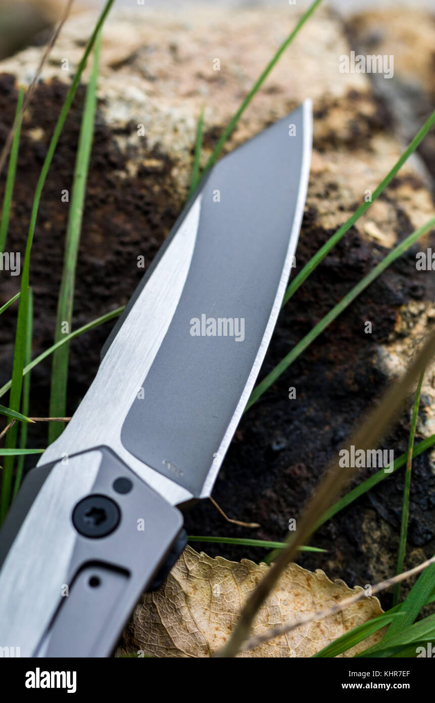 Blade of sharp knife. Blade on the background of stones. The iron ...