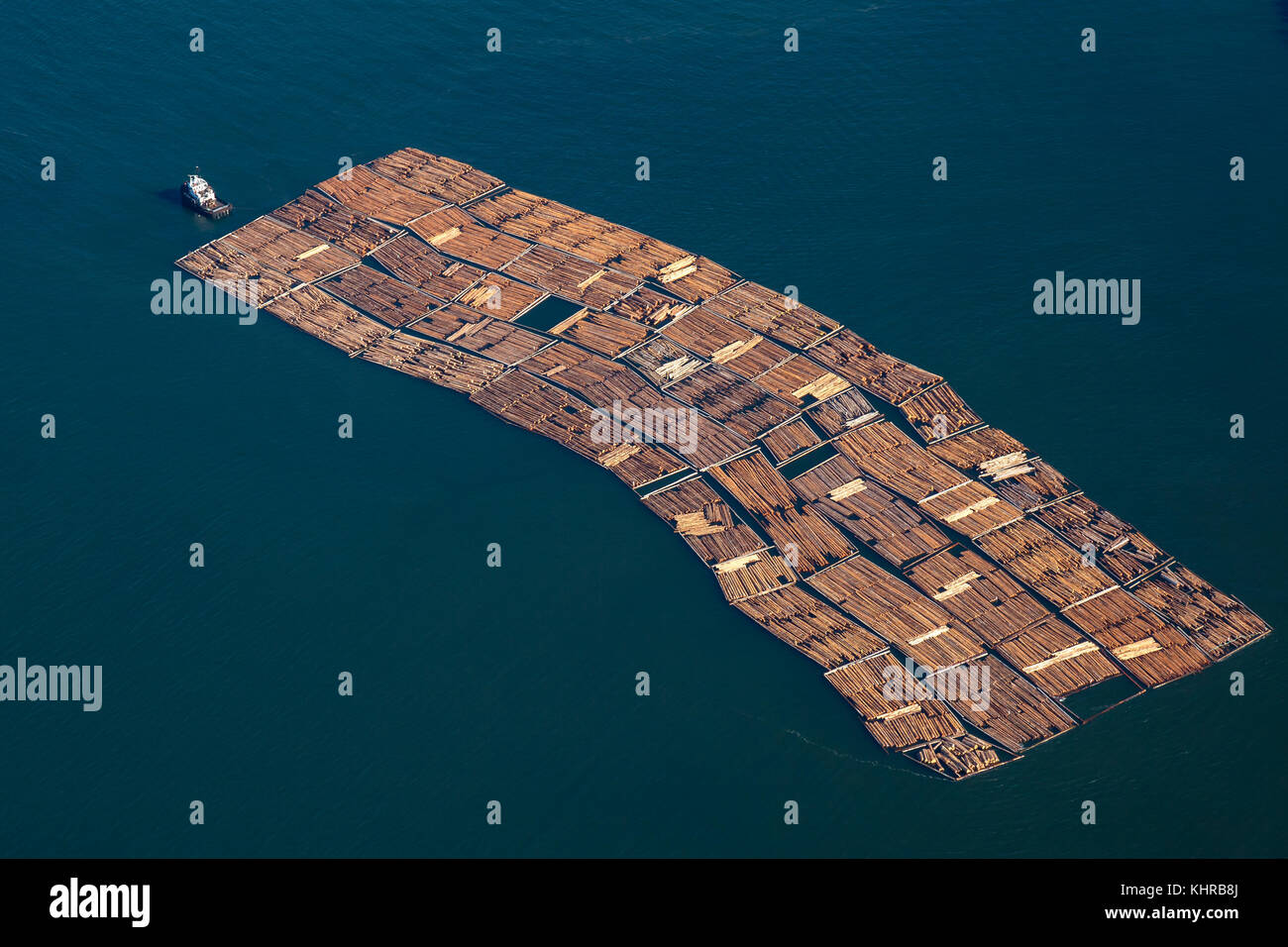 Tug boat pulling lumber wood in the ocean. Taken from aerial ...