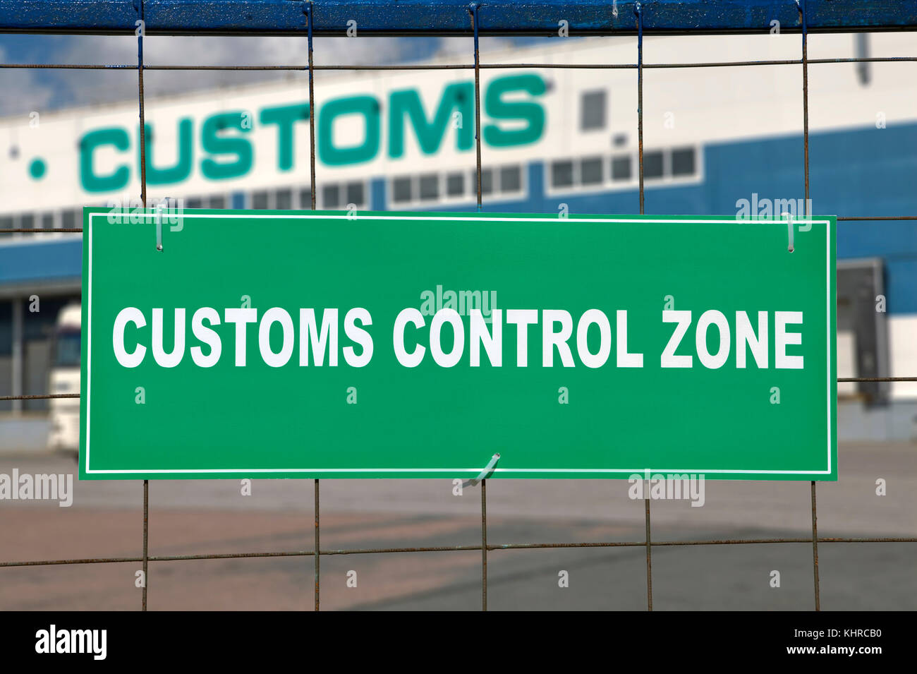 Warehouse of the customs logistics terminal behind the fence with a ...