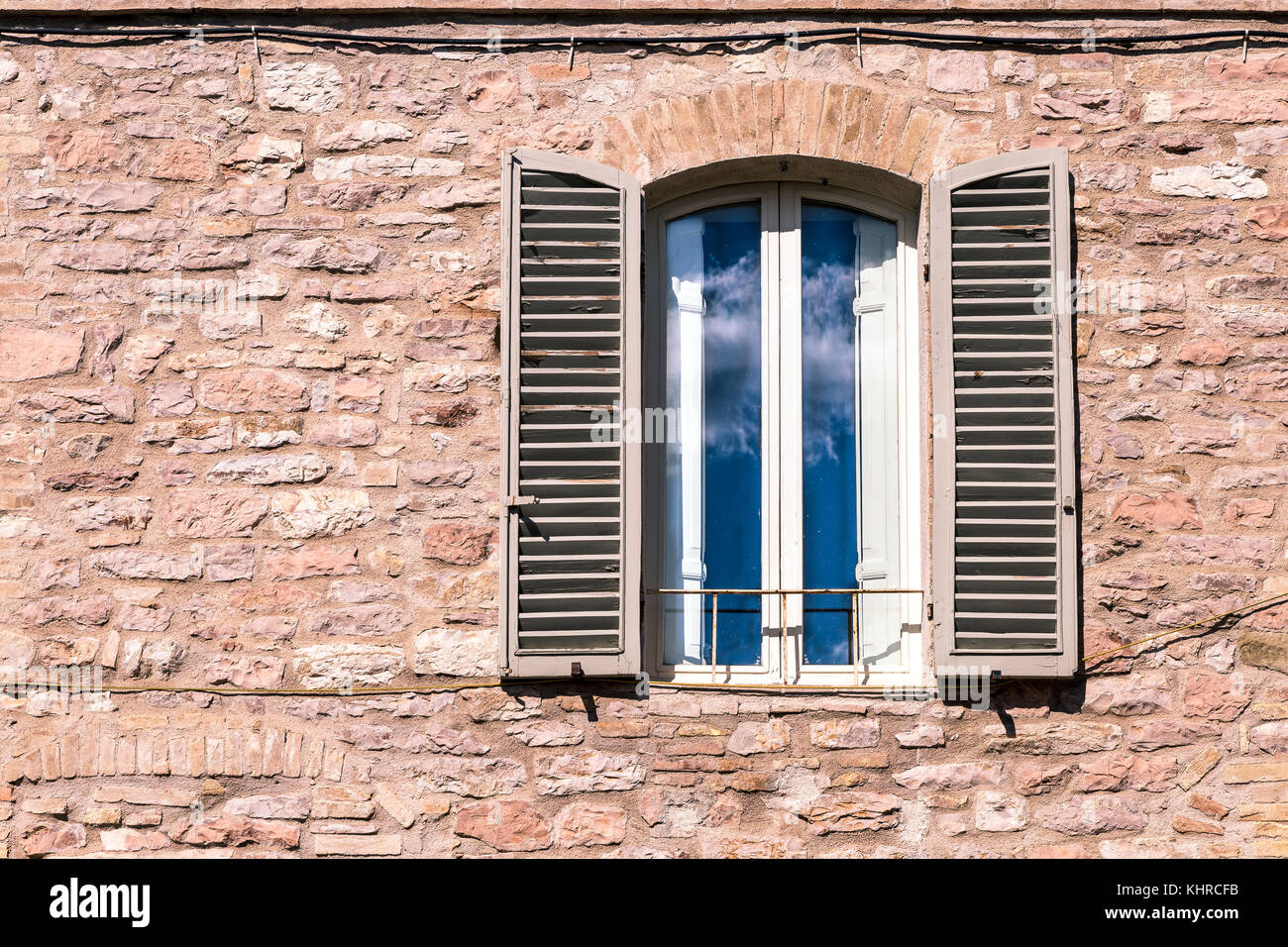 Assisi (Italy): Window on medieval stone wall Stock Photo - Alamy