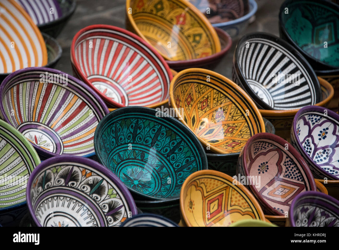 colorful plates & dishes in traditional painted designs on sale in a ...