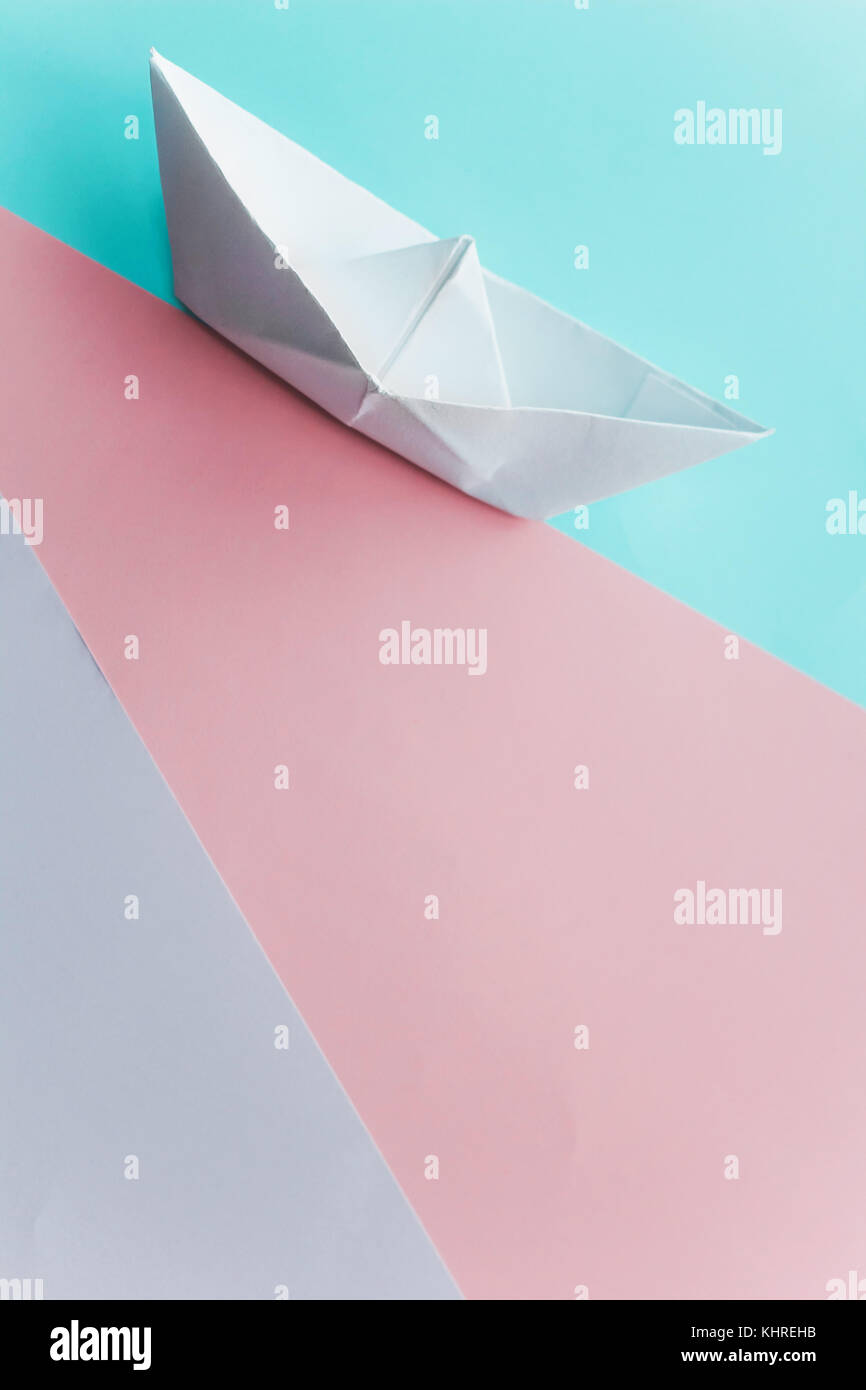origami paper boat on pastel background Stock Photo - Alamy
