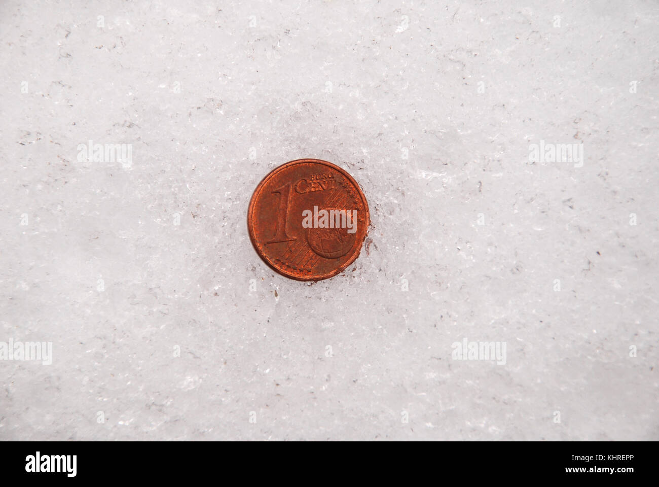 The lost coins on a snow. Euro coin Stock Photo - Alamy