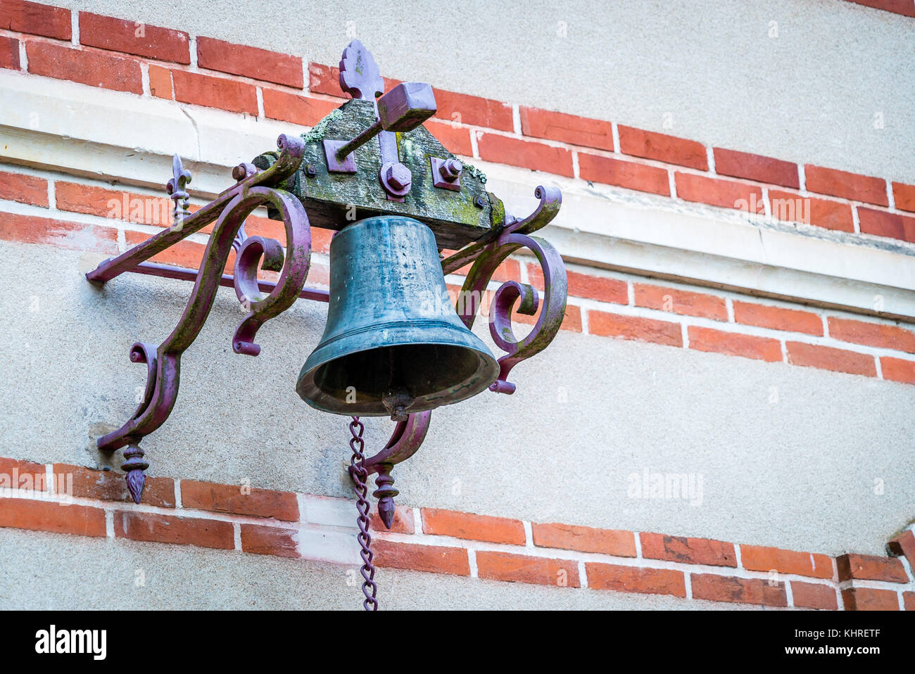Old outdoor bell that used to be rung at school Stock Photo - Alamy