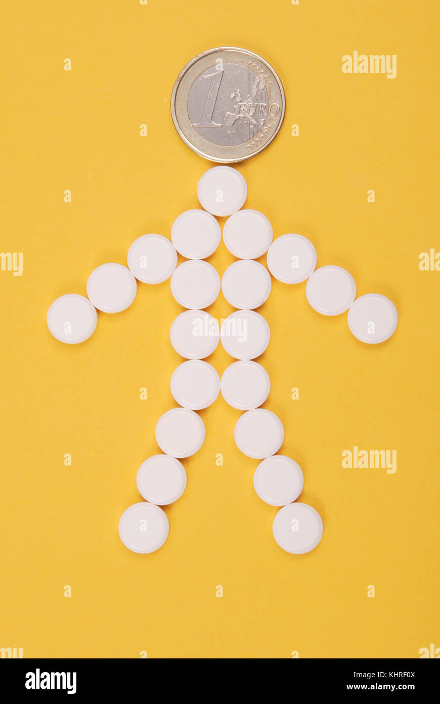 Little man combined from white tablets. Instead of a head a coin one ...