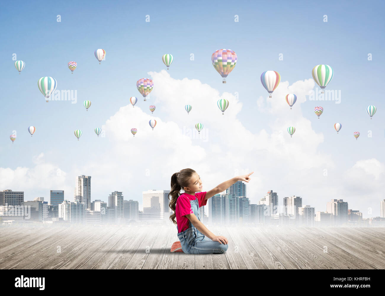 Concept of careless happy childhood with girl pointing at something ...