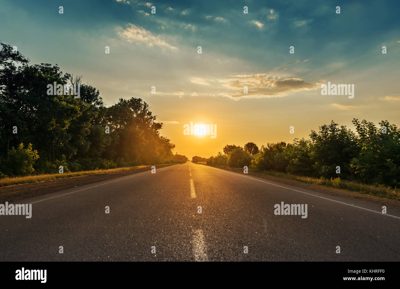 sun in horizon over asphalt road Stock Photo - Alamy