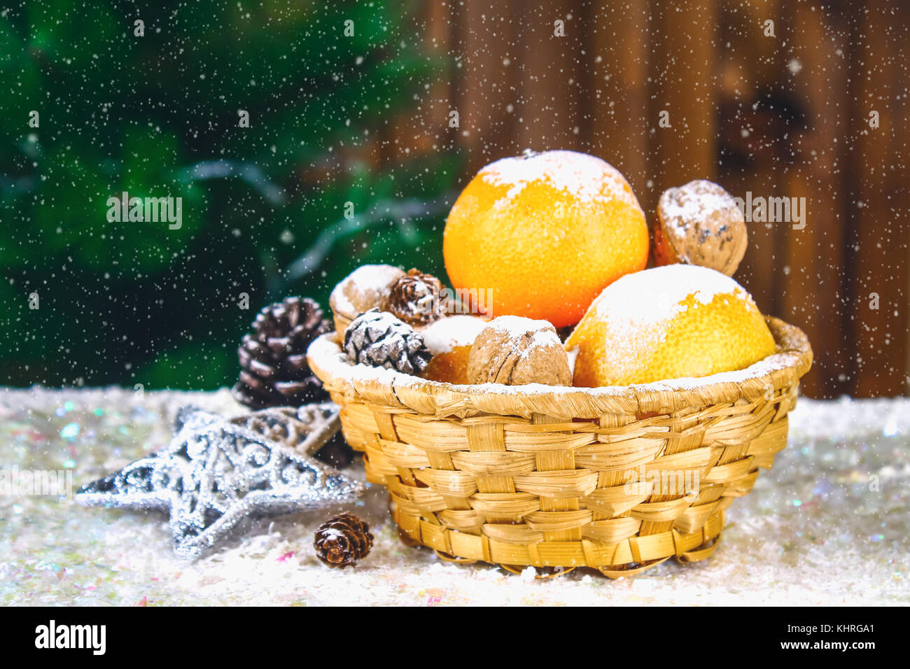 Mandarins, walnuts and bumps in a basket on the background of a ...