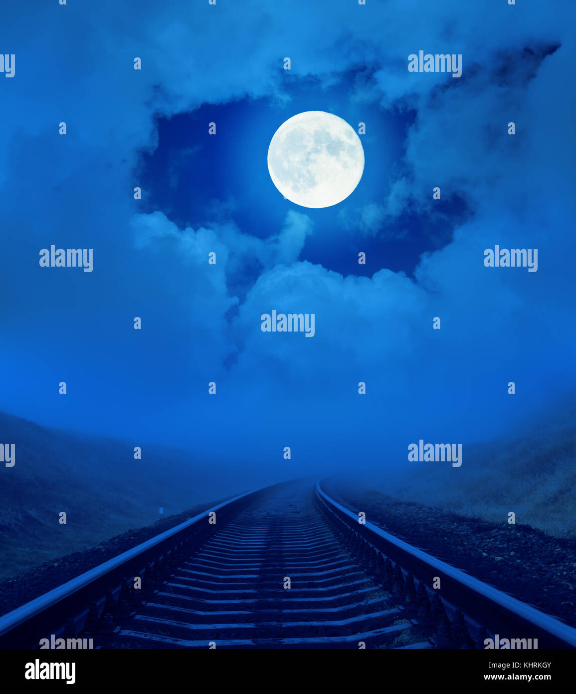 full moon in clouds over railroad Stock Photo - Alamy