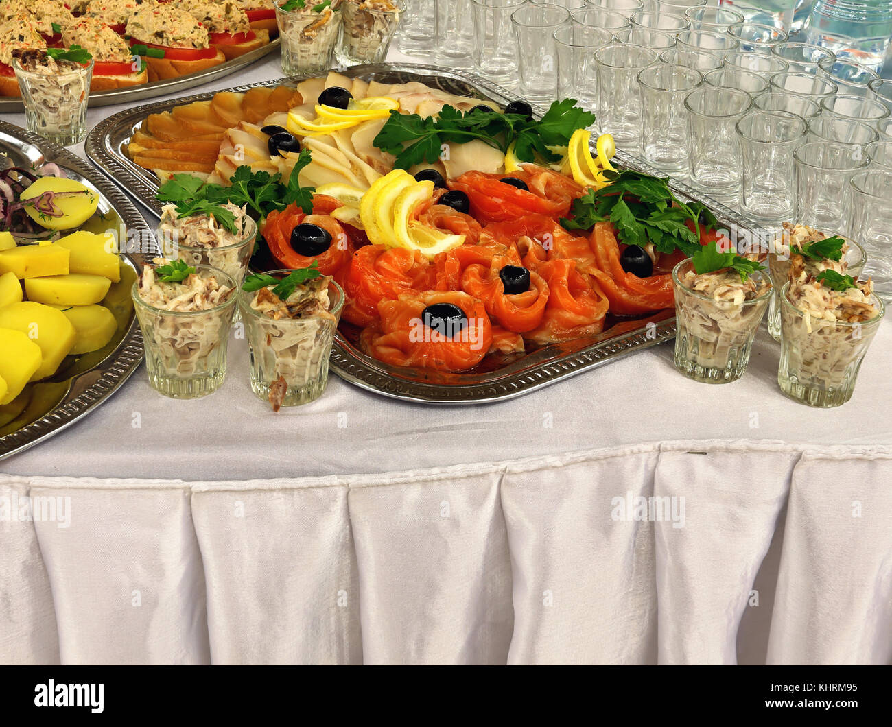 Table with sandwiches, snacks, appetizers and pickles on a white ...