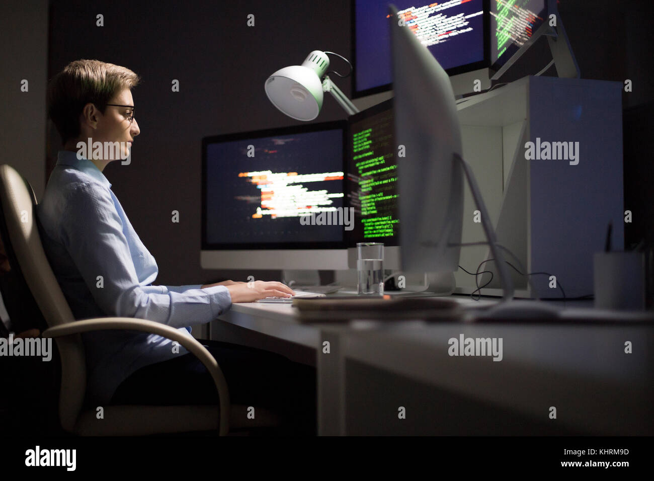 Portrait shot of concentrated middle-aged software developer wrapped up ...