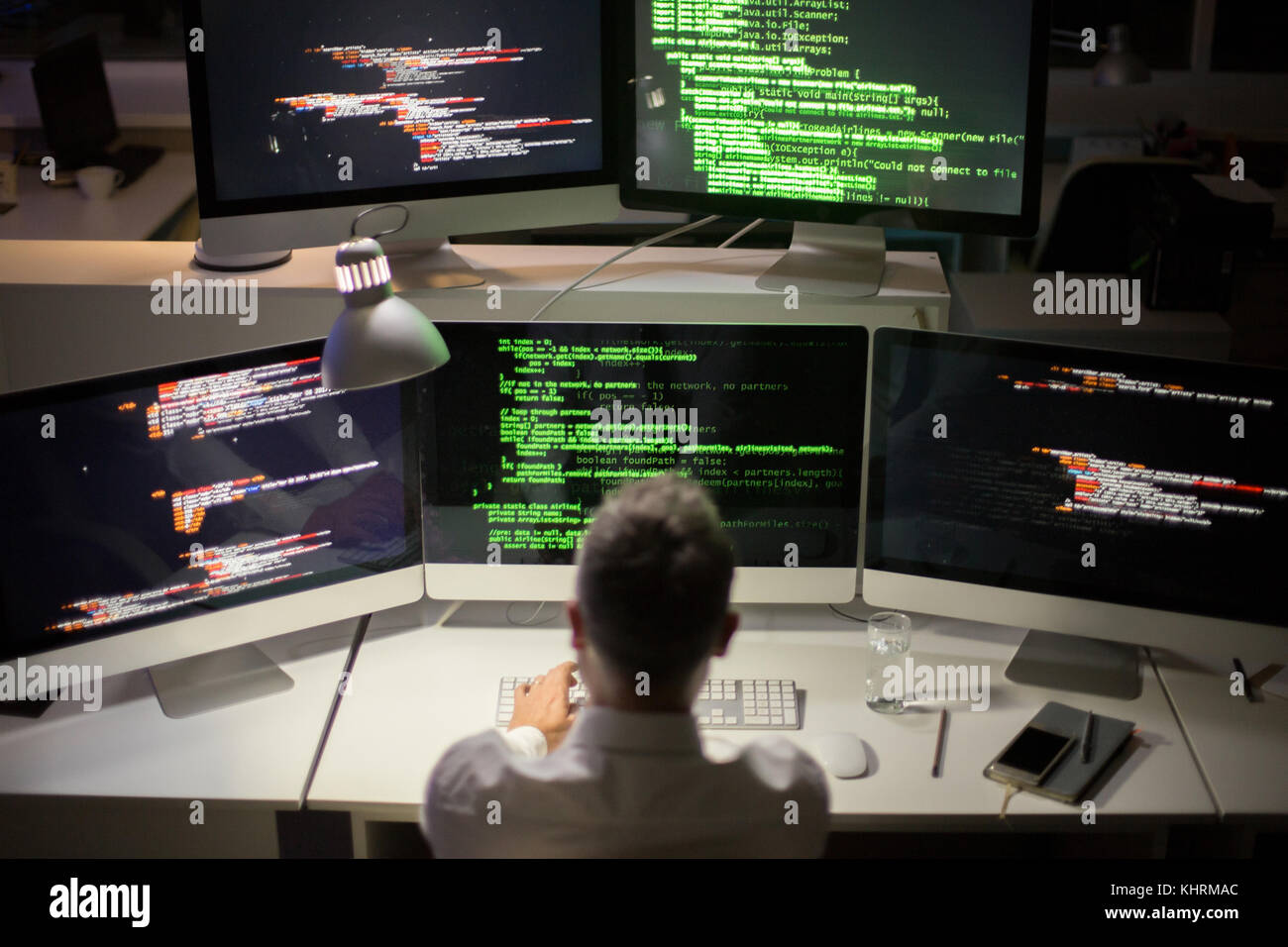 Unrecognizable gray-haired software developer writing code while ... Unrecognizable gray-haired software developer writing code while ...