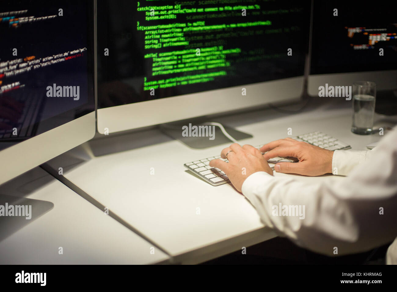 Close-up shot of unrecognizable programmer wrapped up in coding while ...