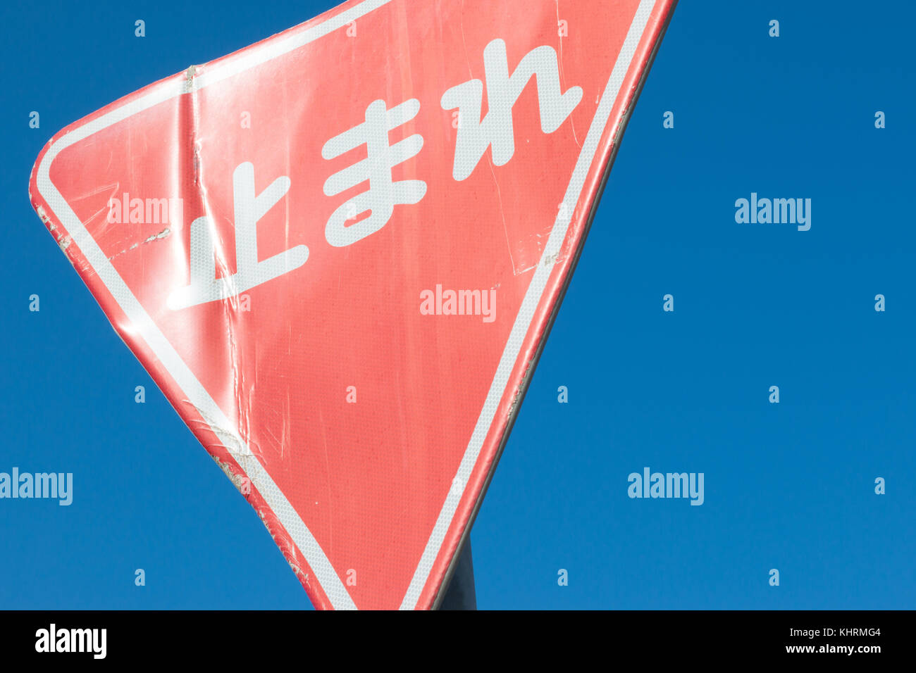 A slightly bent stop sign in Japan Stock Photo - Alamy