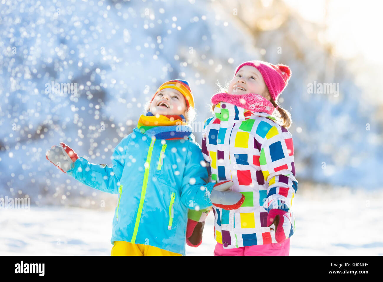 Kids playing in snow. Children play outdoors on snowy winter day. Boy ...