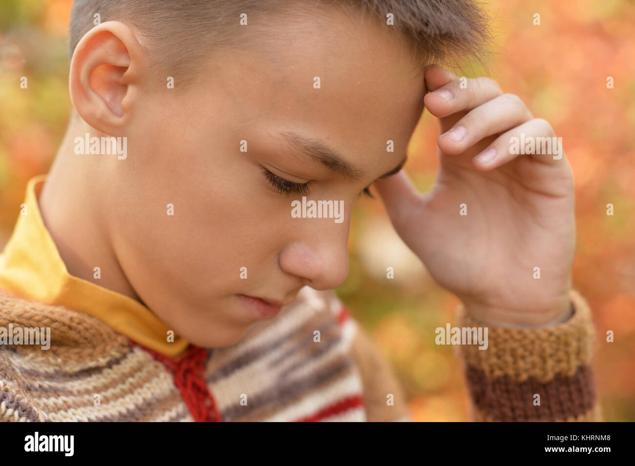 Portrait of a sad little boy outdoors in autumnal park Stock Photo - Alamy