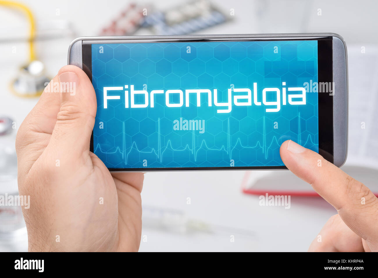 Smartphone with the text Fibromyalgia on the display Stock Photo - Alamy