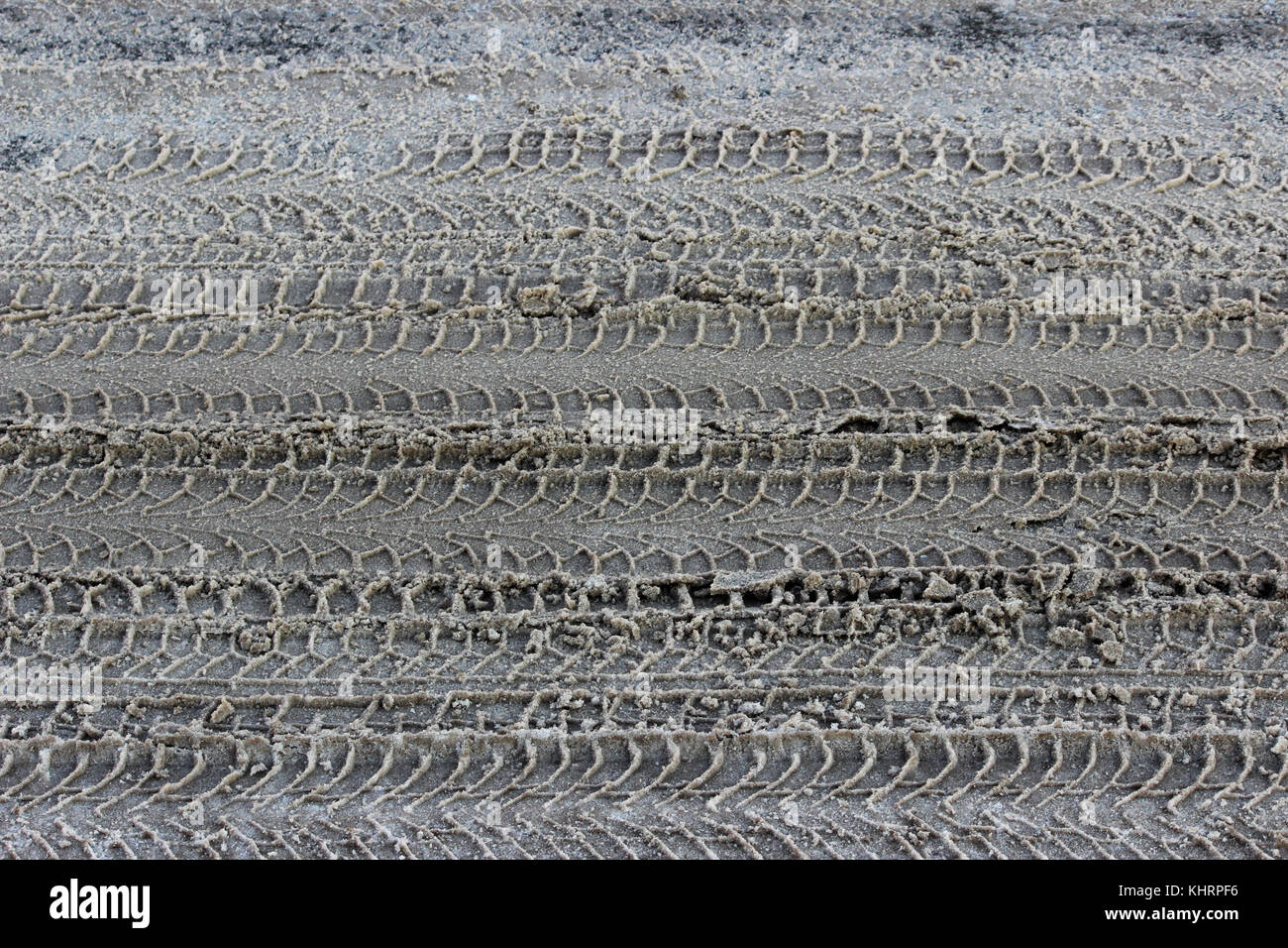 Many detail footprints wheel tracks in the mud snow Stock Photo - Alamy