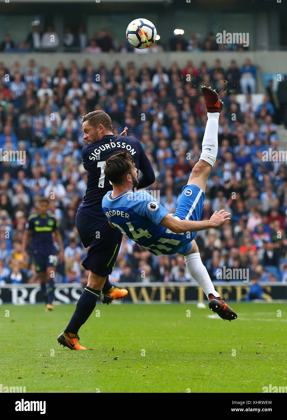 Davy Propper of Brighton strikes an over head kick as he's challenged ...