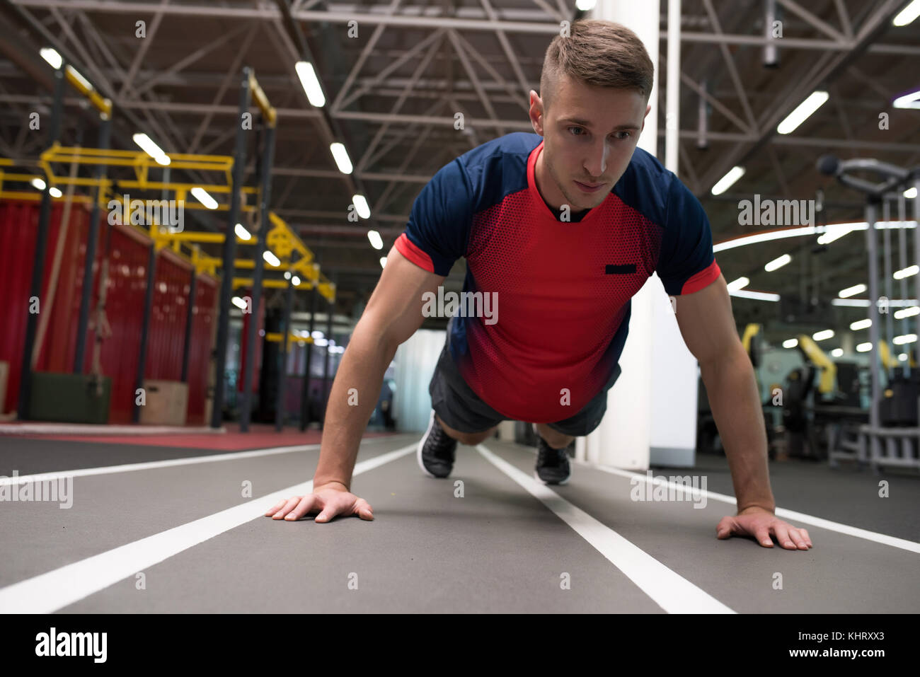Full length Portrait of handsome young man doing fitness exercises on ...