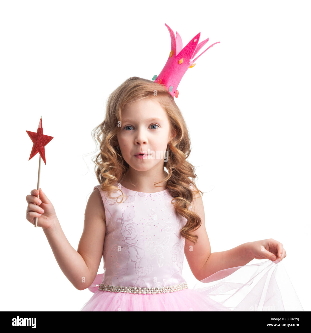 Little fairy girl in pink dress and crown with magic wand putting spell ...