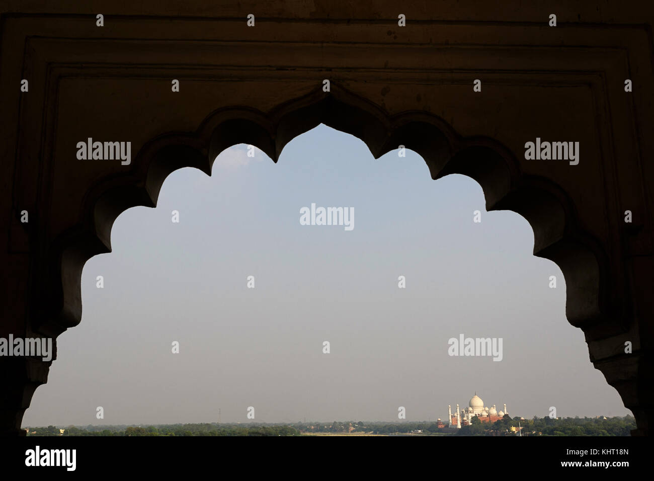 View of Taj Mahal trough an ornated window arch at Red Fort, framed and ...