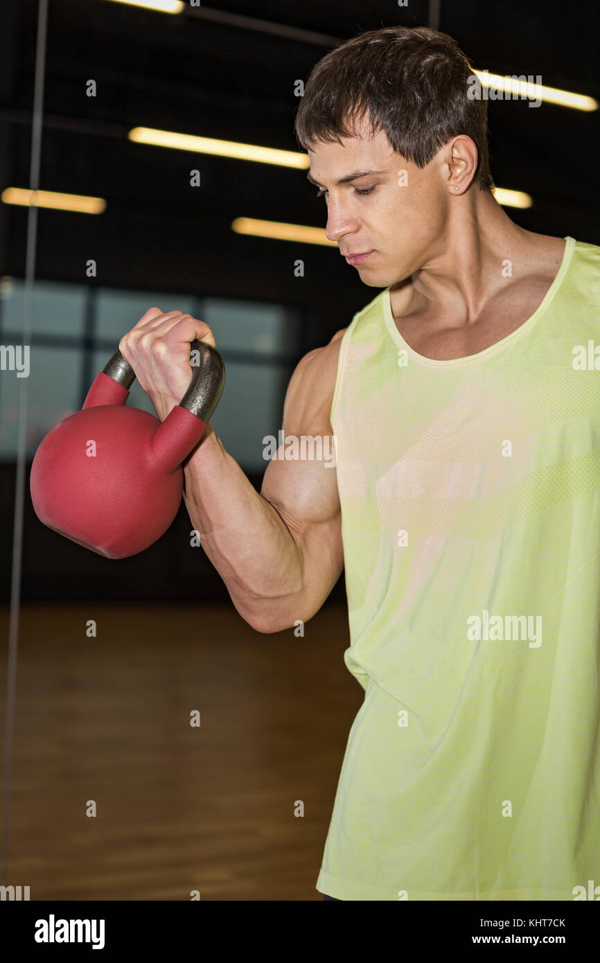 Young man training with weights in the gym Stock Photo - Alamy