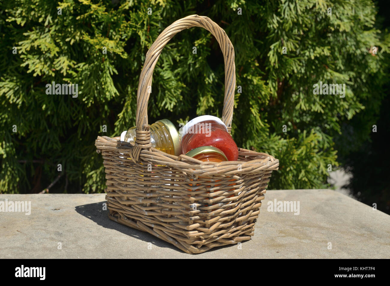 Small basket with small jars with jam for breakfast shot outdoor Stock ...