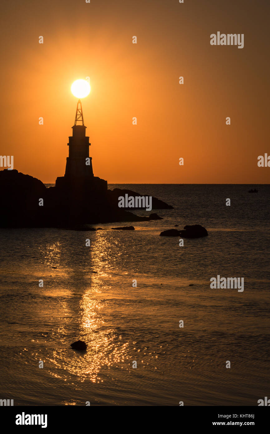 Sunrise in gold, the silhouette of the lighthouse near Ahtopol ...