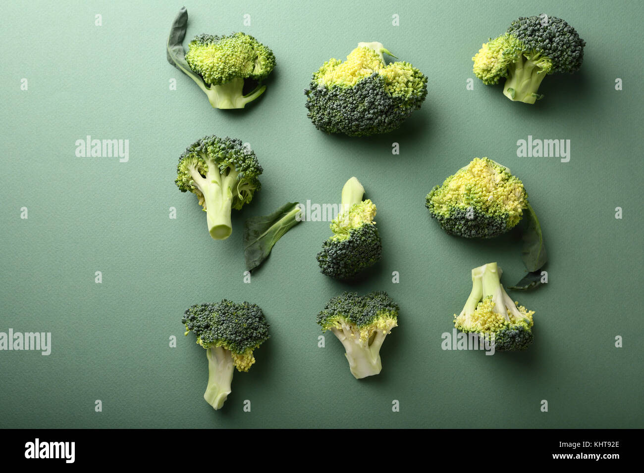 Fresh broccoli on green background Stock Photo - Alamy