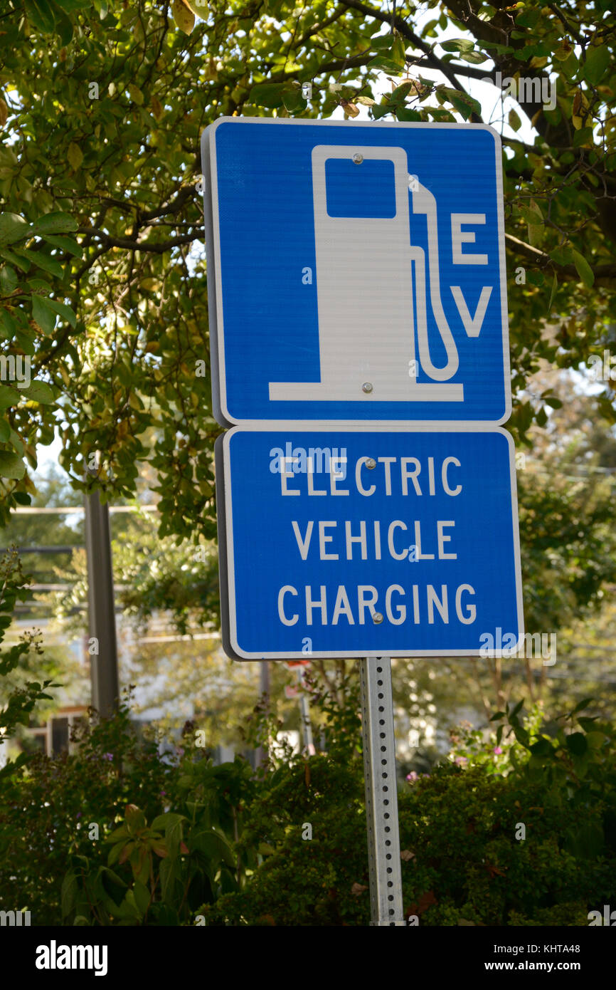sign for an electric vehicle that is charging Stock Photo - Alamy