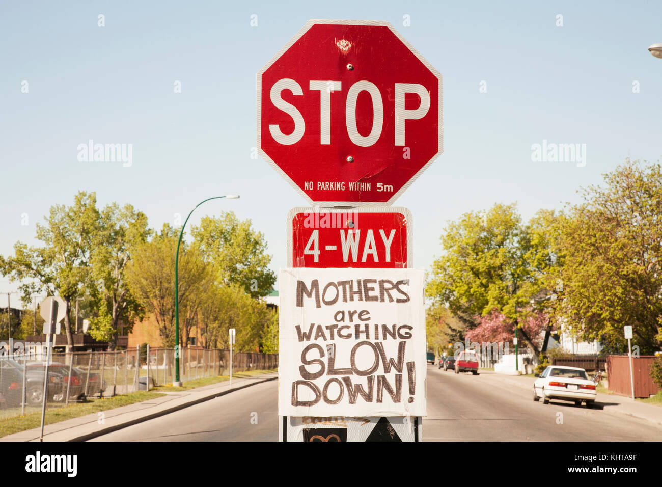 Stop sign with message to slow down. Calgary, Alberta Stock Photo - Alamy