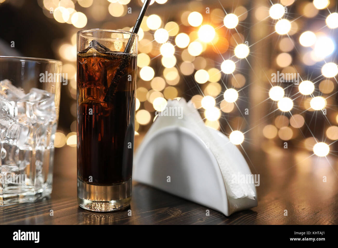 glass of cold alcohol drink with ice on table Stock Photo - Alamy
