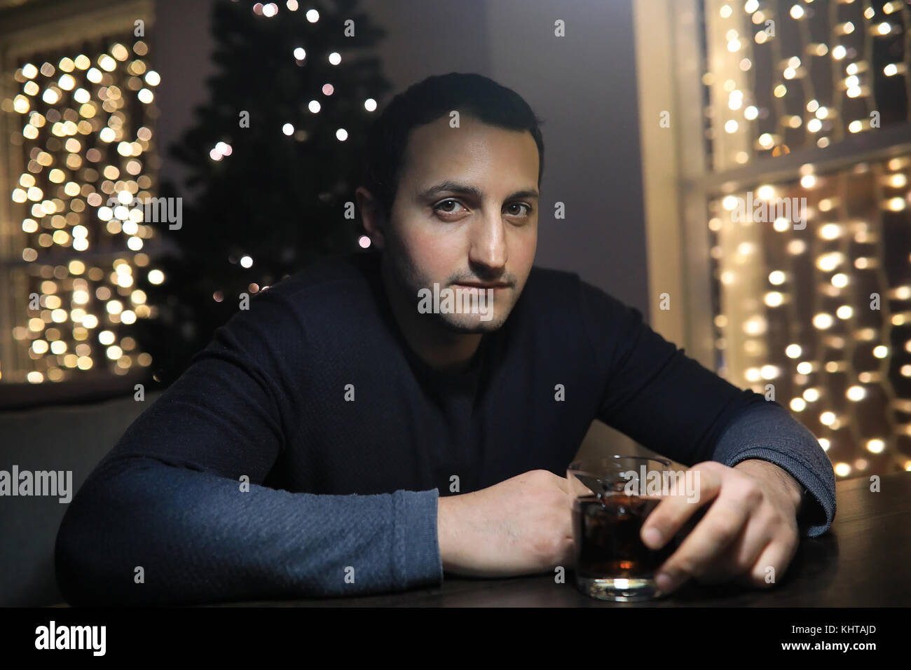 man with glass of whisky in the pub on night Stock Photo - Alamy