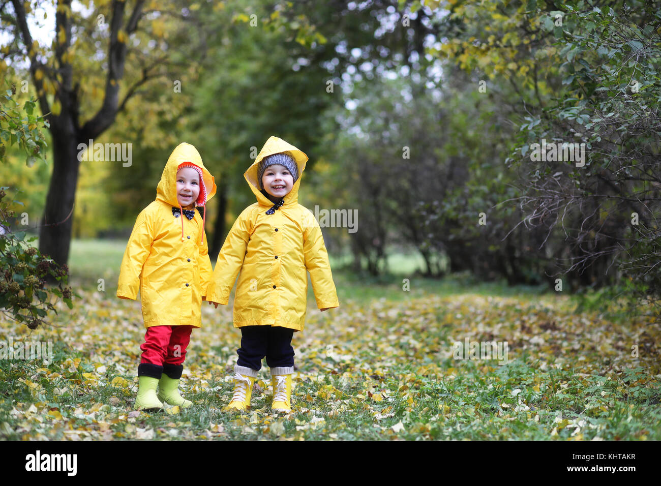 Children in the autumn park walk Stock Photo - Alamy