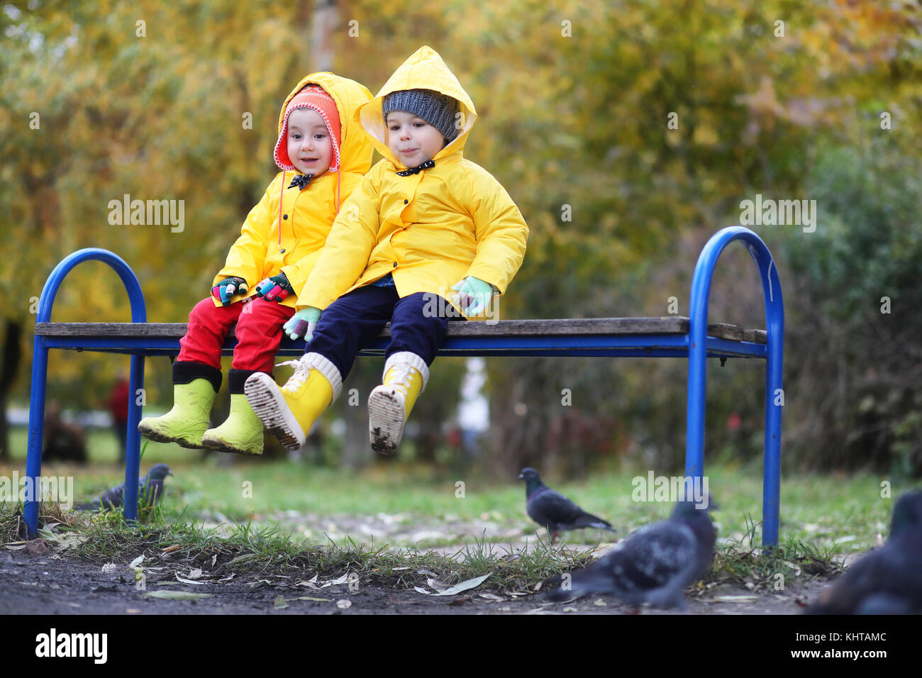 Children in the autumn park walk Stock Photo - Alamy