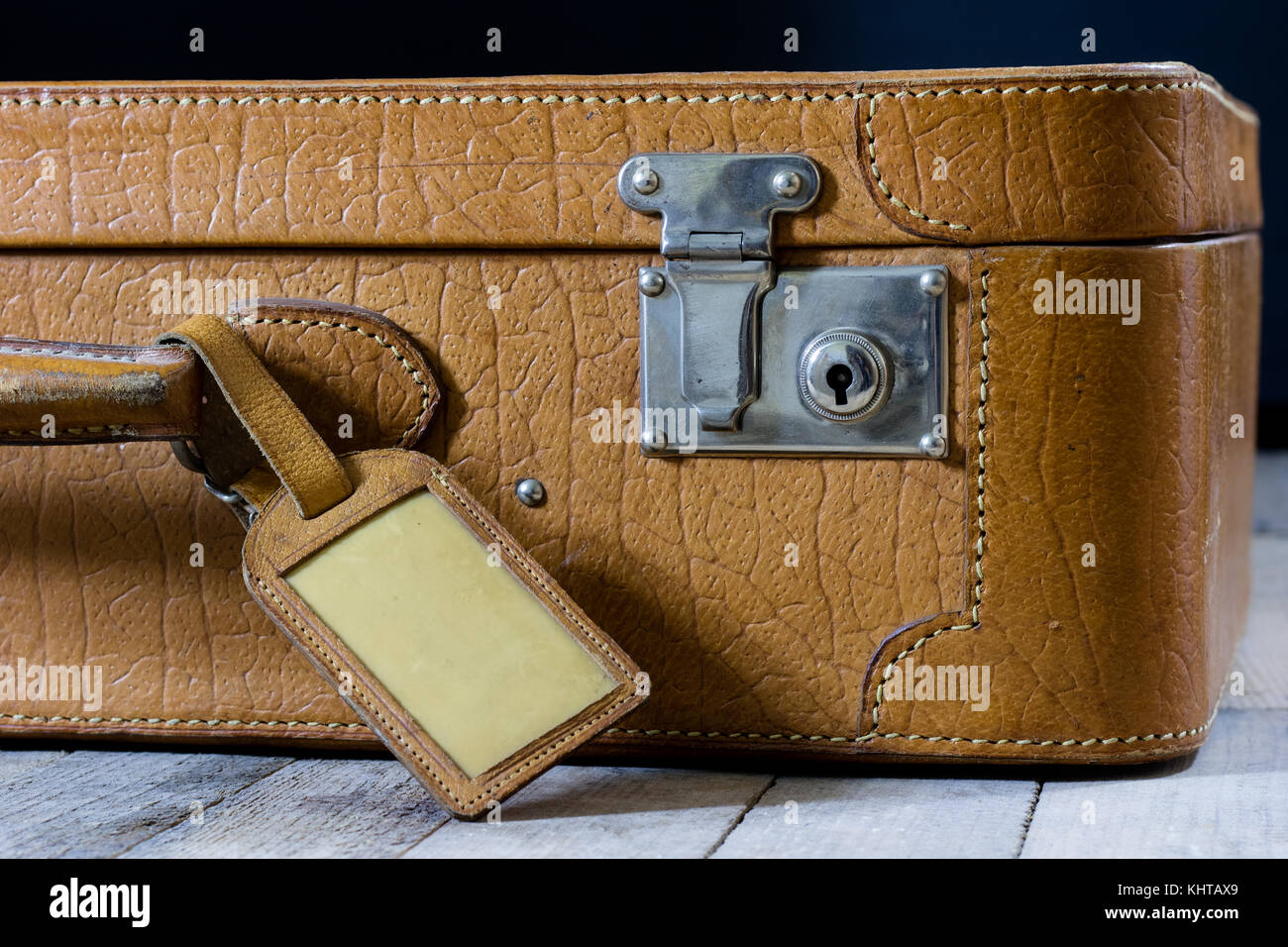 Old stylish suitcase. Lock with the key in the bag. Suitcase on a ...